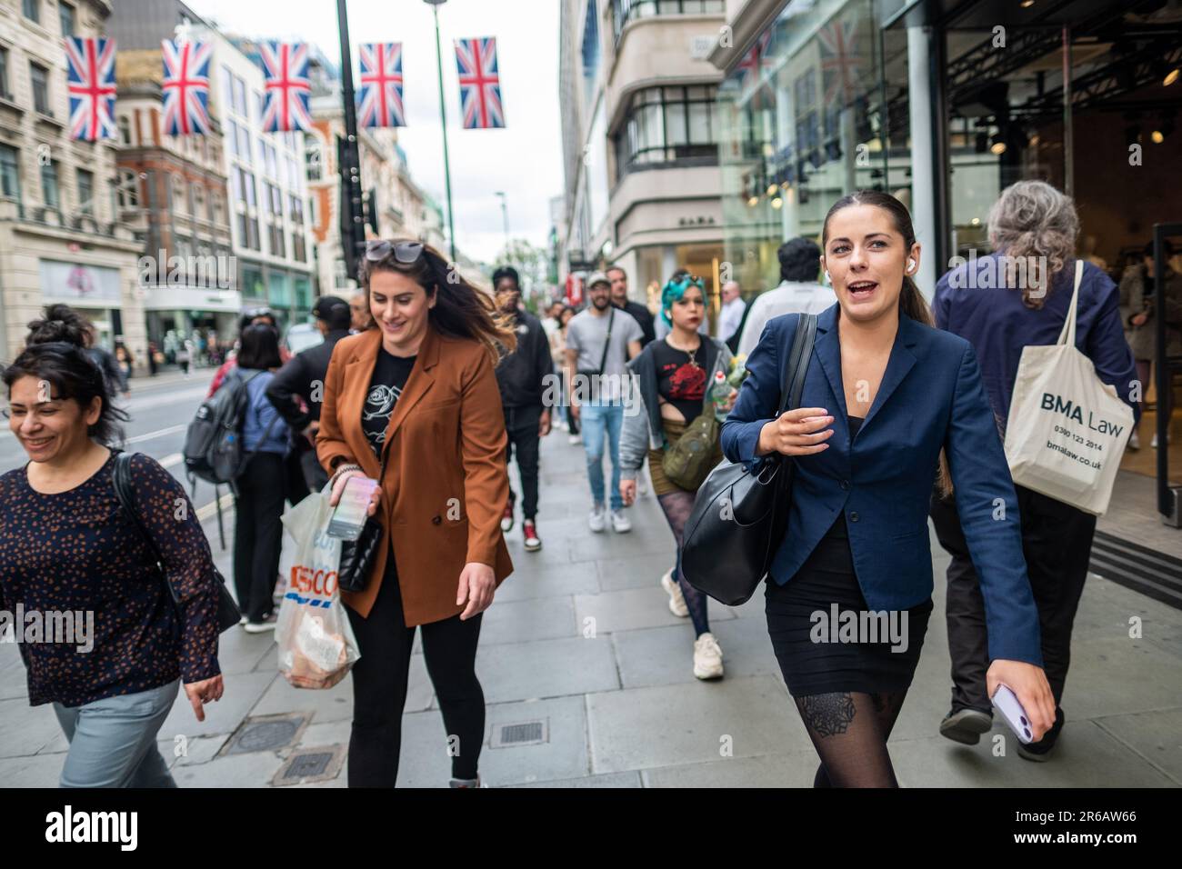 London- May 2023: Shoppers on Oxford Street, a landmark high street and ...