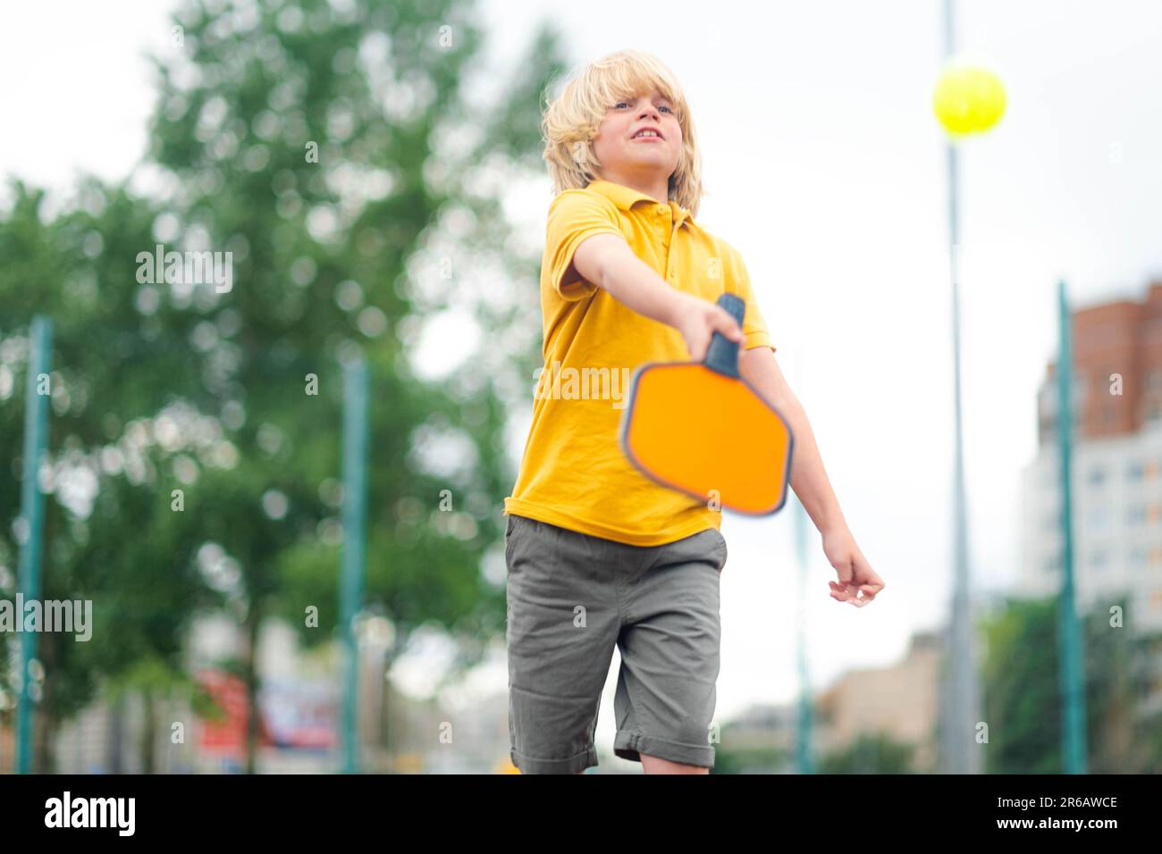 Happy blonde boy playing pickleball hi-res stock photography and images ...