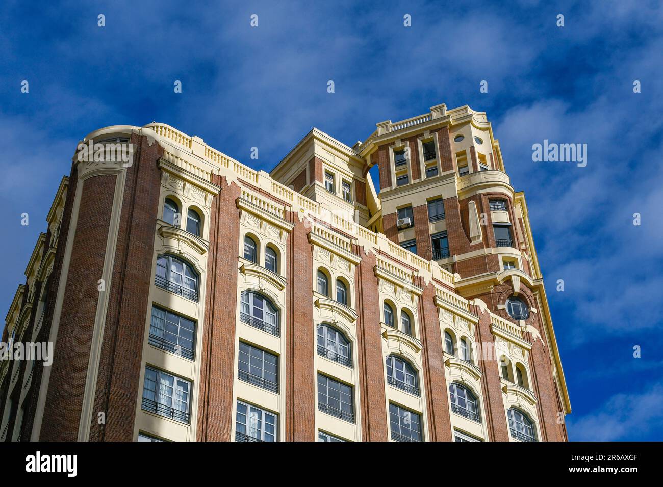 An expansive red brick building with numerous windows which allows ...