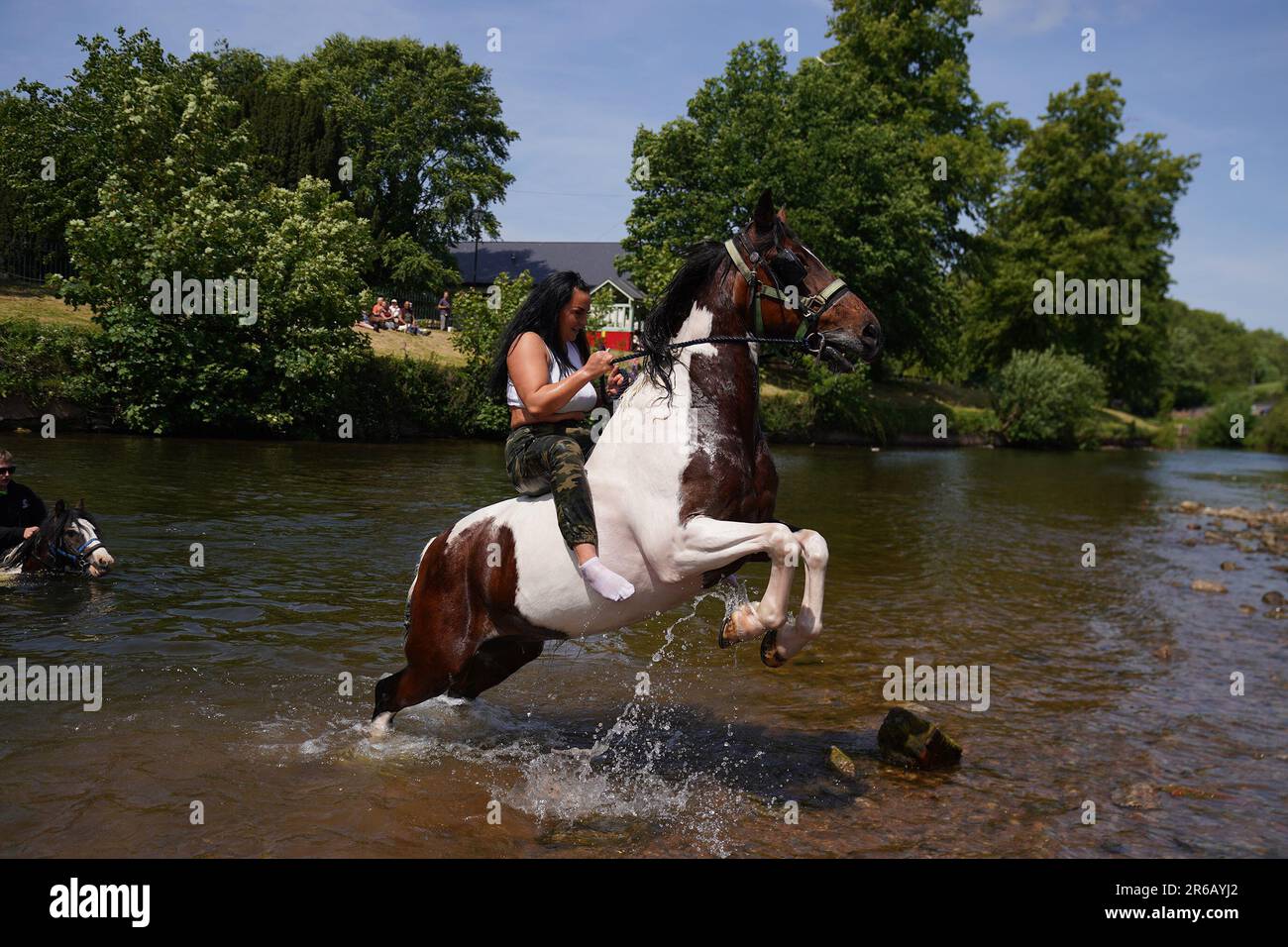 A women rides her horse through the river during the Appleby Horse Fair ...