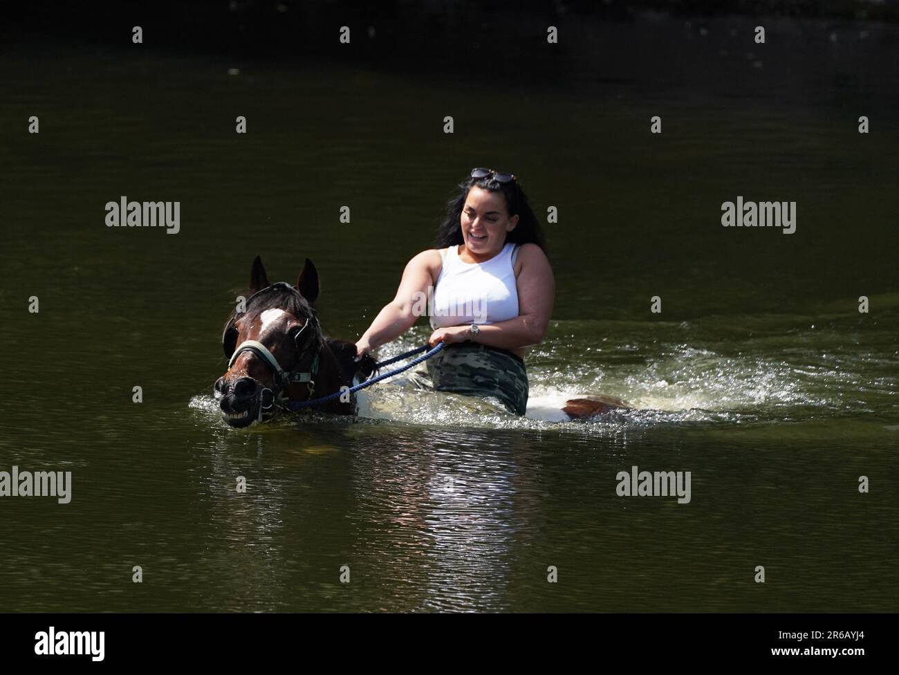 A women rides her horse through the river during the Appleby Horse Fair ...
