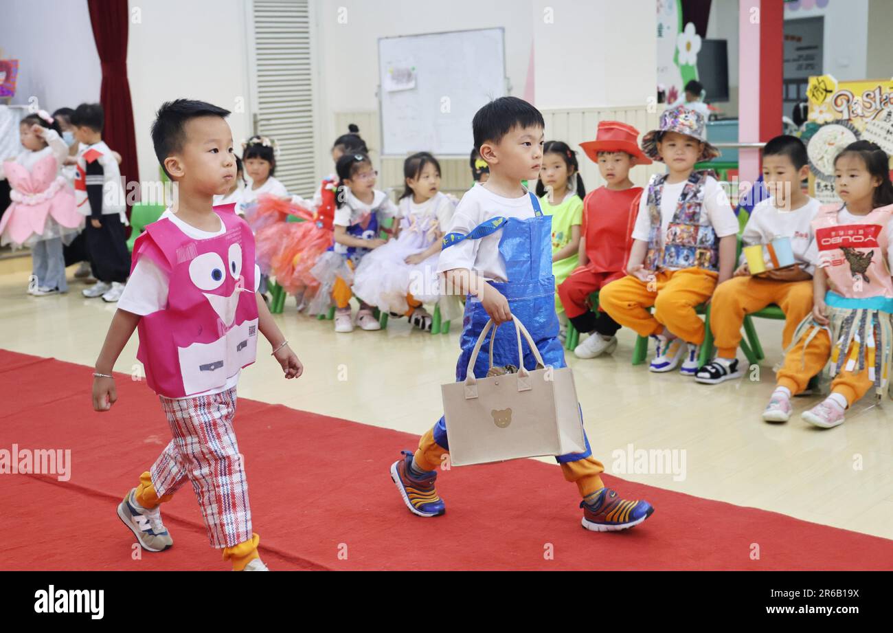 Children show clothing made of waste materials at a kindergarten to ...