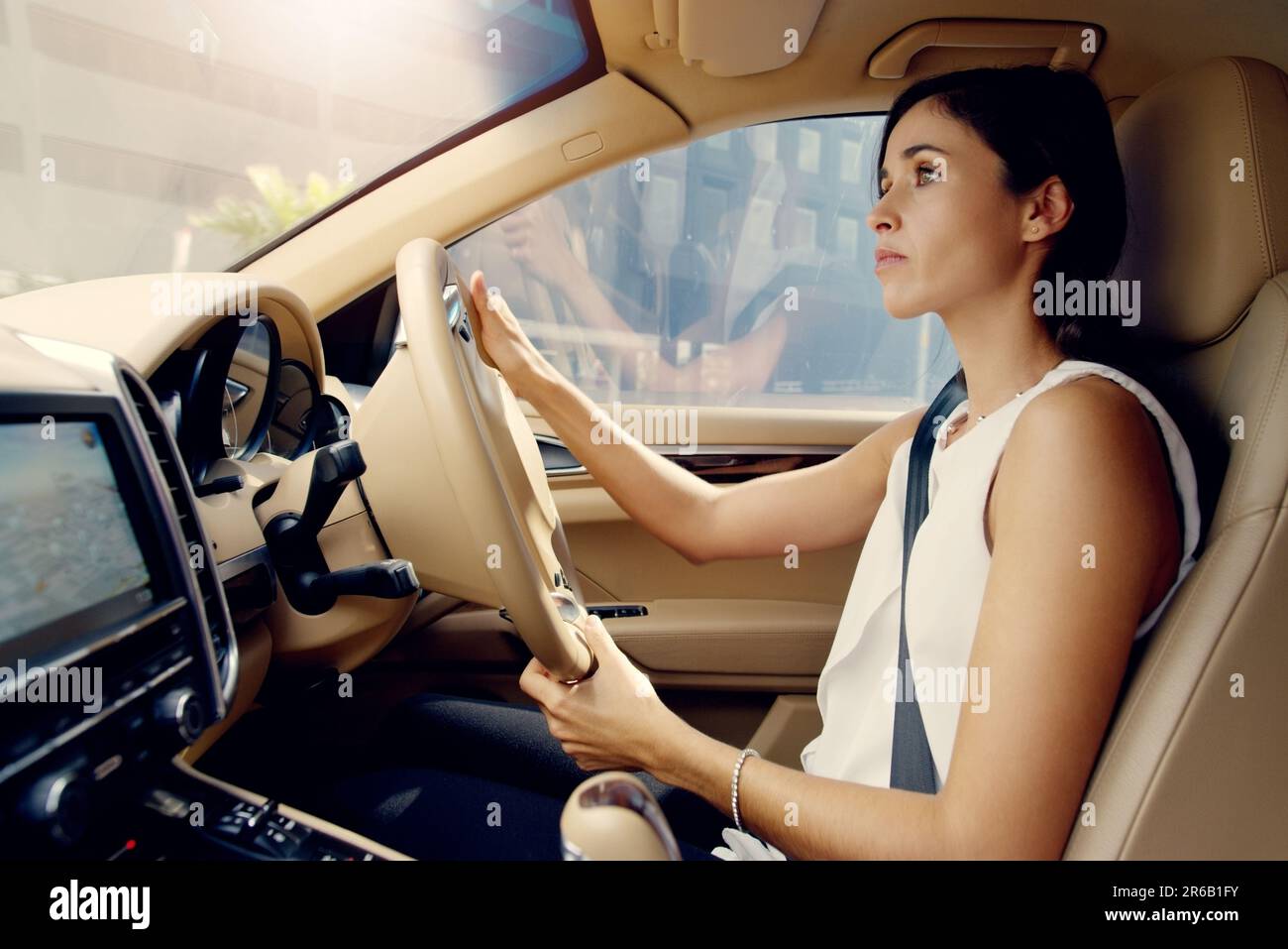 Woman, car and driver with a city road traveling to work and job. Young ...