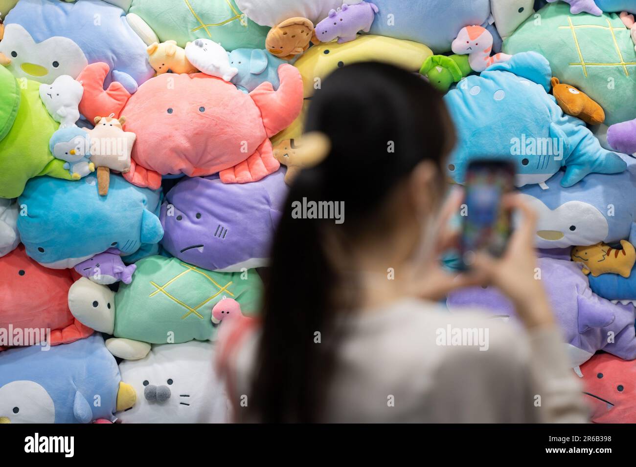 Tokyo, Japan. 8th June, 2023. A visitor takes photos of toys exhibited ...