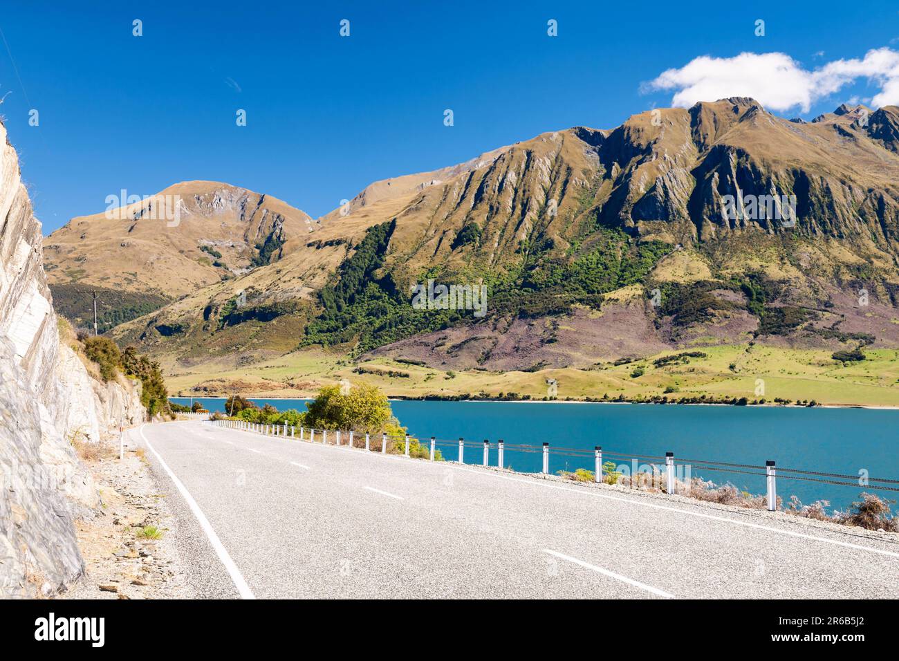 Winding road with wire rope safety barrier (WRSB) along scenic Hawea ...