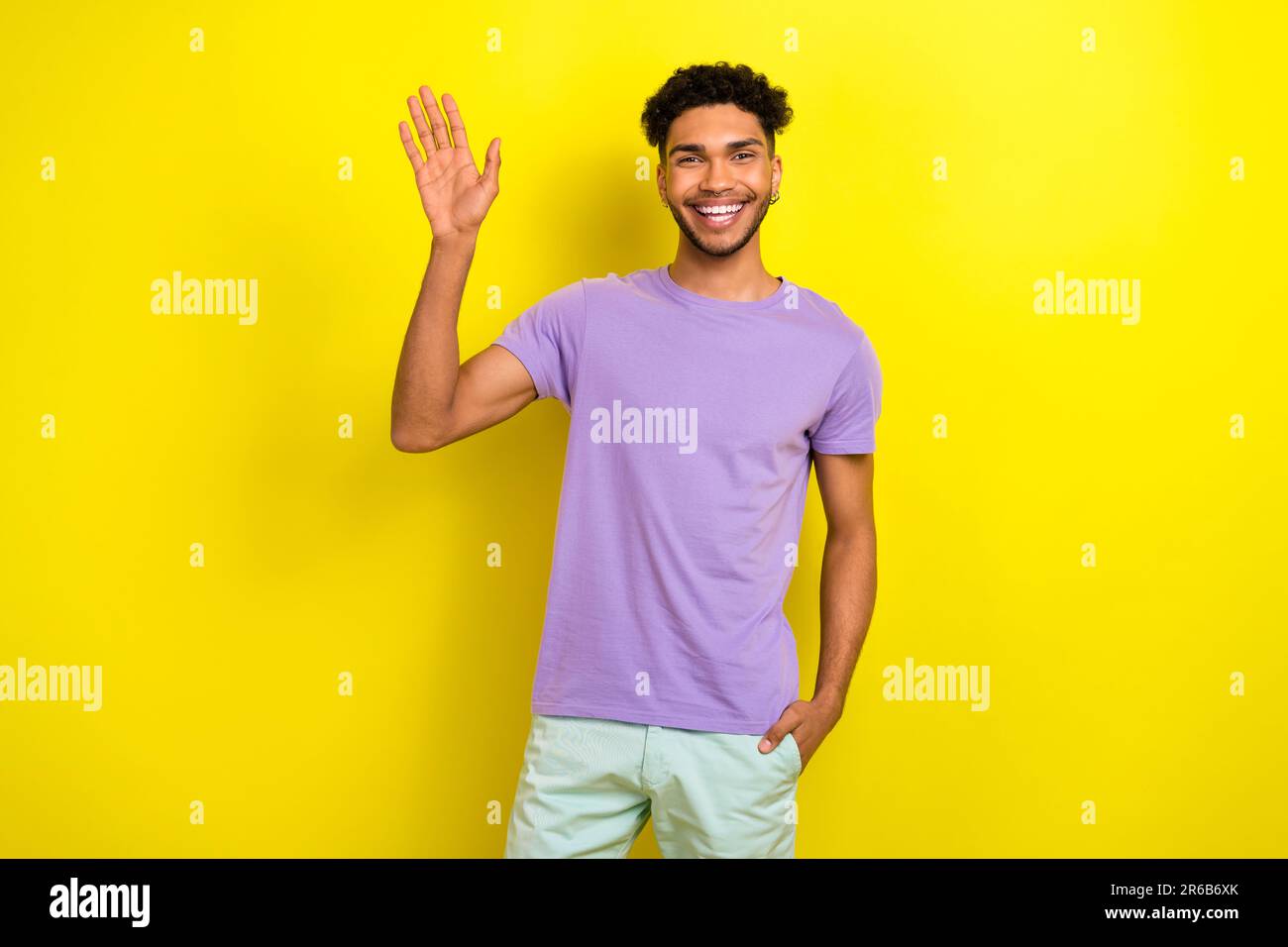 Photo of attractive excited man wear violet t-shirt smiling waving arm ...