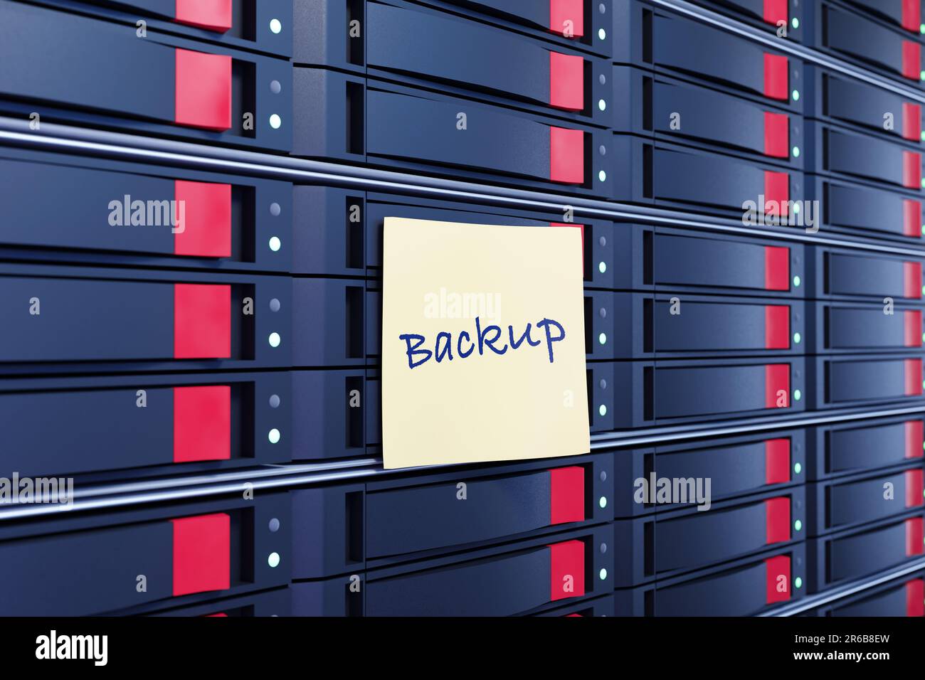 Yellow sticky note written with the word Backup stuck on stacks of ...