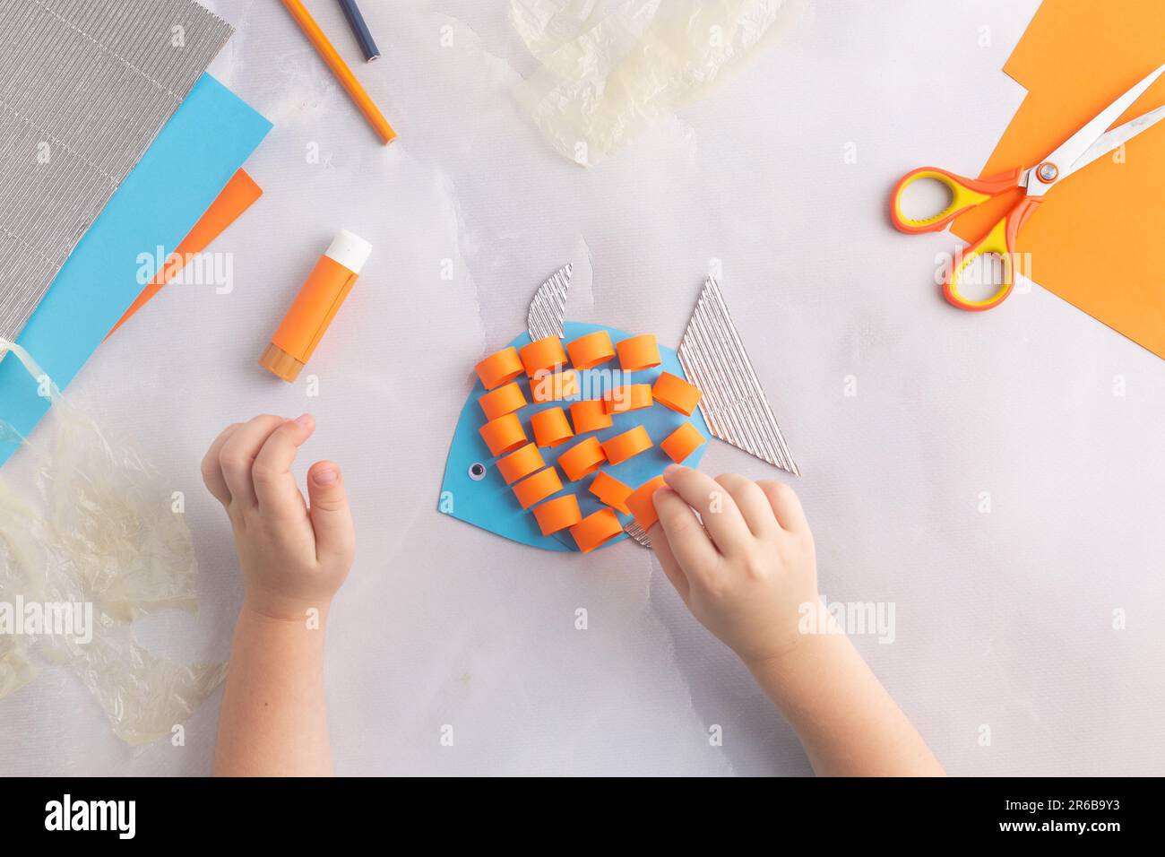 Paper adorable fish with children at home. Hands making DIY summer ...