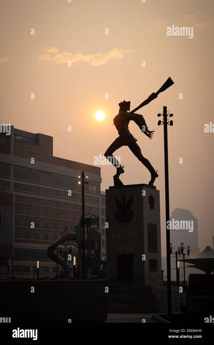 The sun rises behind the One World Trade Center, while the smoke from ...