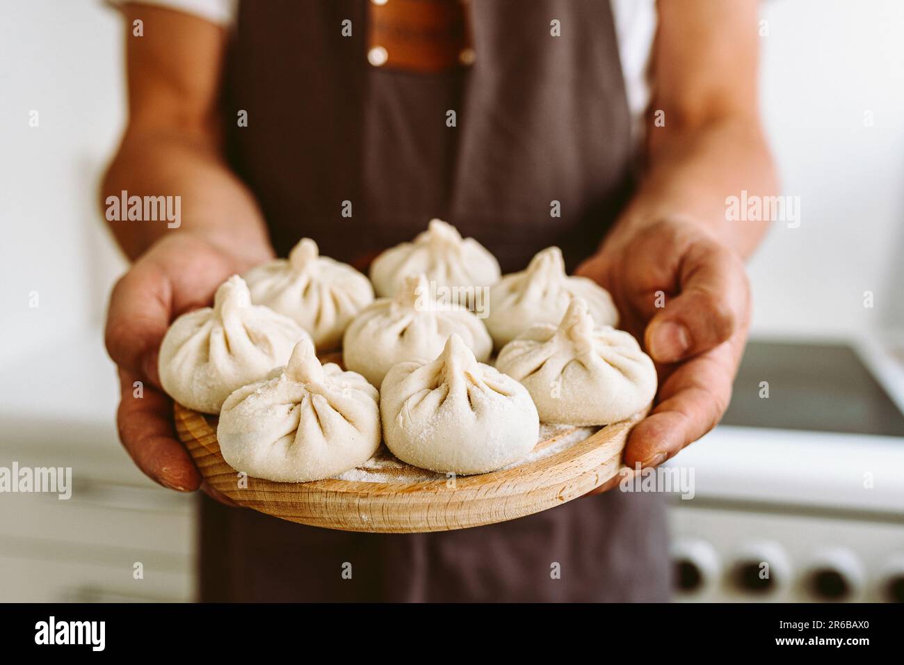 portrait unrecognizable male chef with cooked khinkali Stock Photo - Alamy