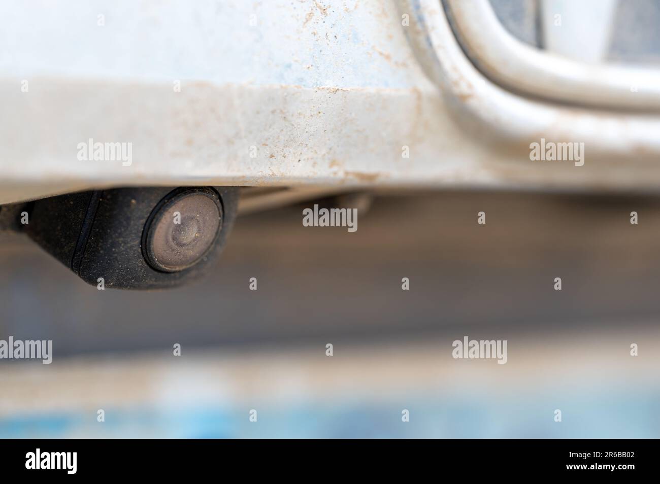 Backup camera on a vehicle obscured with dirt, mud, and dust so that ...