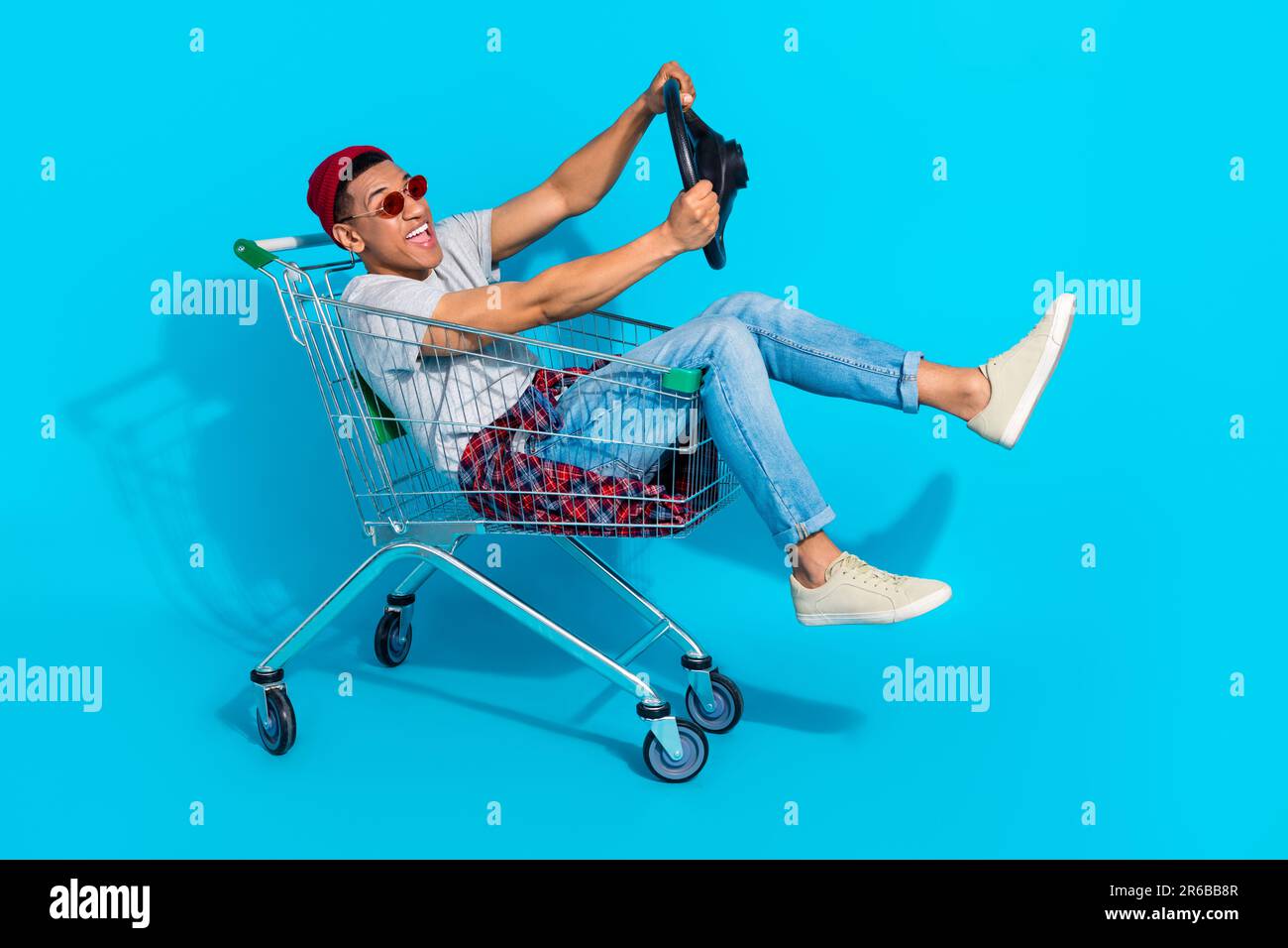 Full length profile photo of cool overjoyed person sit mall trolley ...