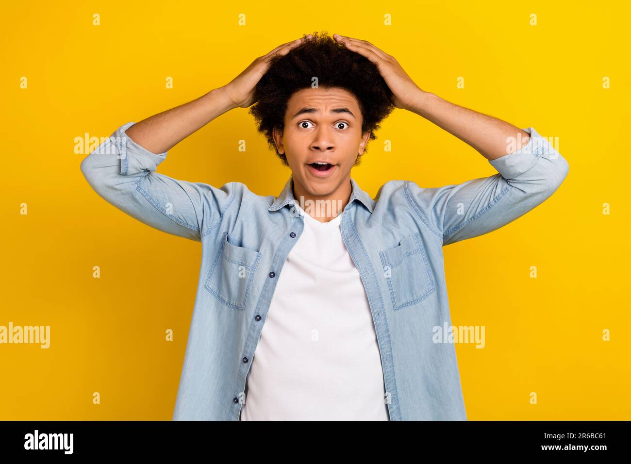 Photo of shocked impressed man wear jeans shirt open mouth arms head ...