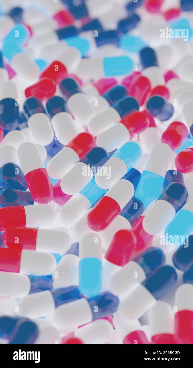 Bunch of shining blue red white capsule pills on a white background ...