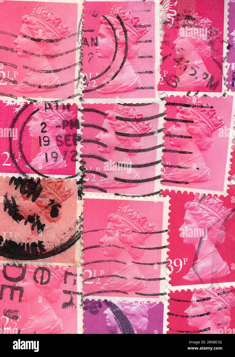 A montage of pink vintage postage stamps from the United Kingdom ...