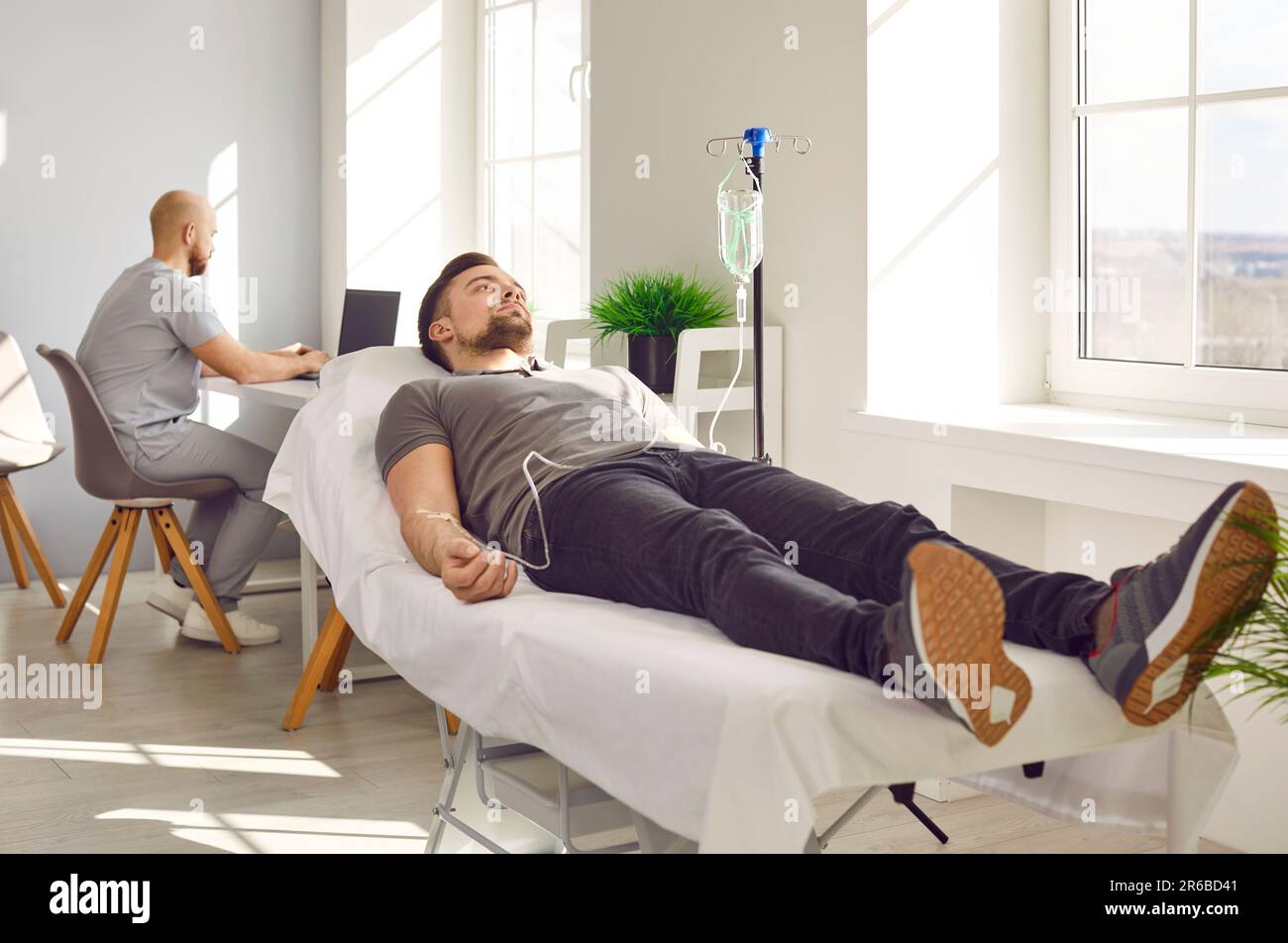 Male patient getting IV infusion in medical office Stock Photo - Alamy