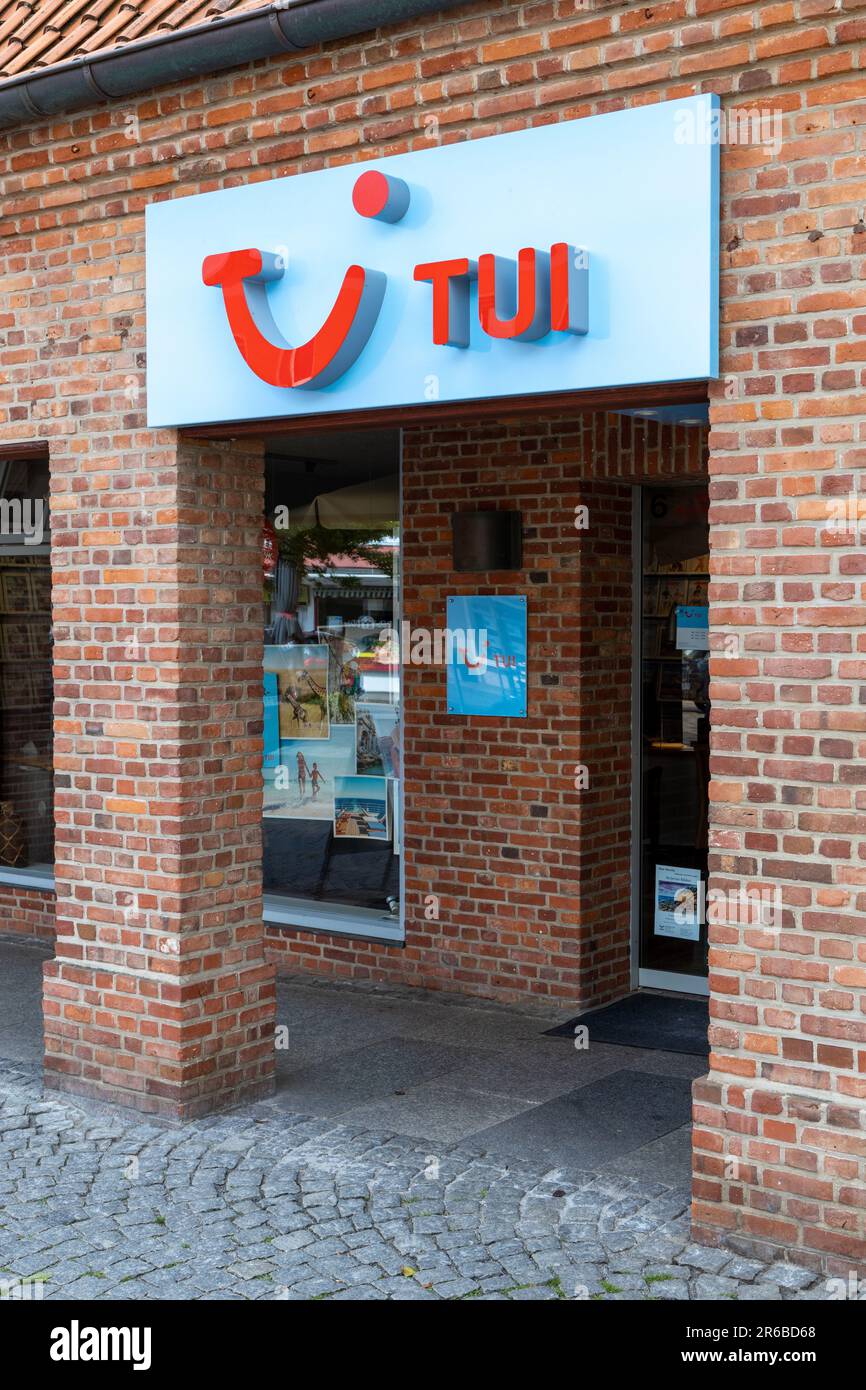 A portrait shot of a brick building with the Tui travel agency branch ...