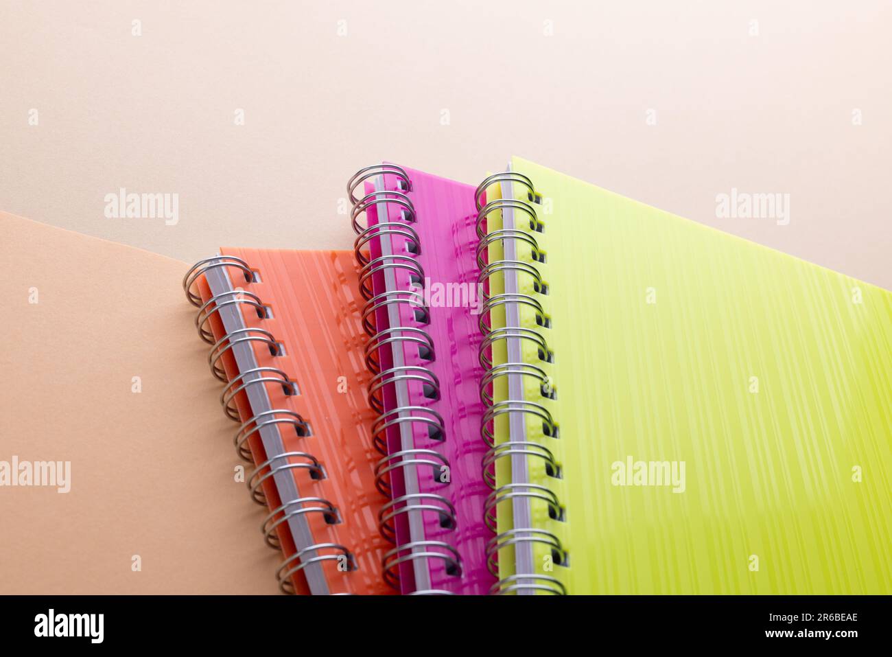 Flat lay of three notebooks with binding with copy space on orange ...