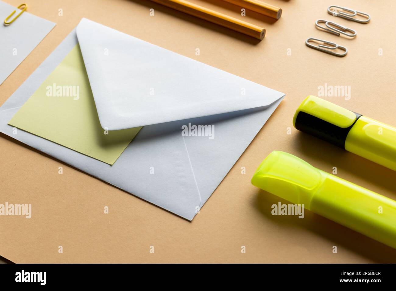 Flat lay of yellow pencils, pen and highlighter and white paper with ...