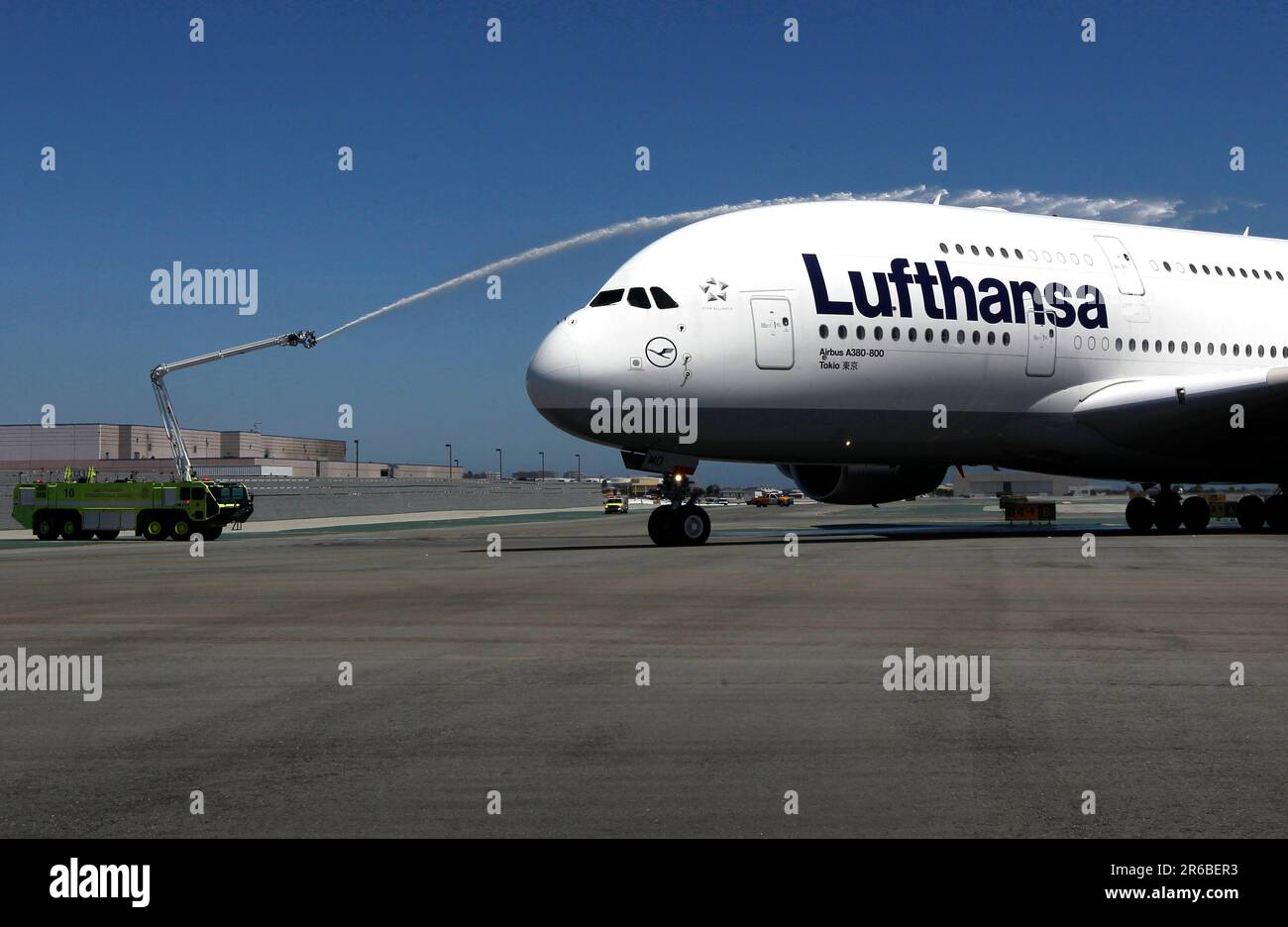 A firetruck welcomes a Lufthansa double-decker Airbus A380 super jumbo ...