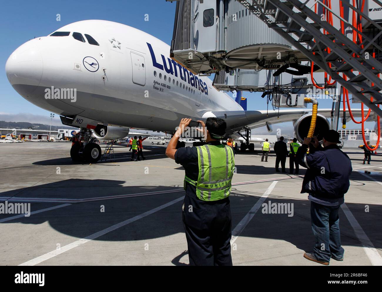 Ground crew personnel snap photos of a Lufthansa Airbus A380 super ...