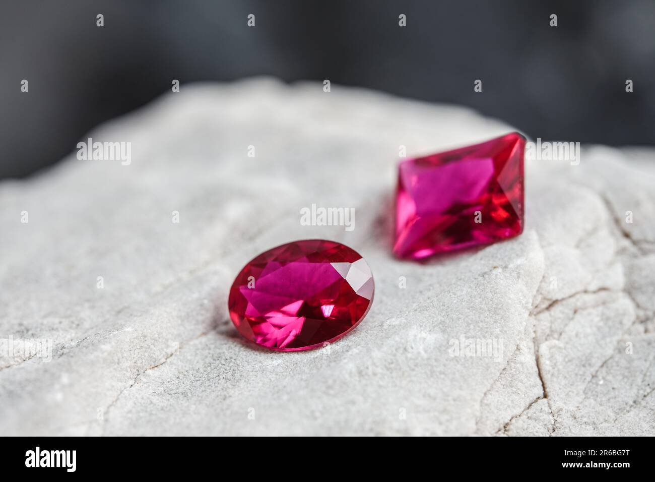 The glimmering natural pink sapphire gemstones on a rugged rock surface ...