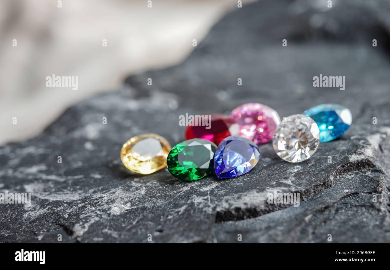 The glimmering natural colorful sapphire gemstones on a rugged rock ...