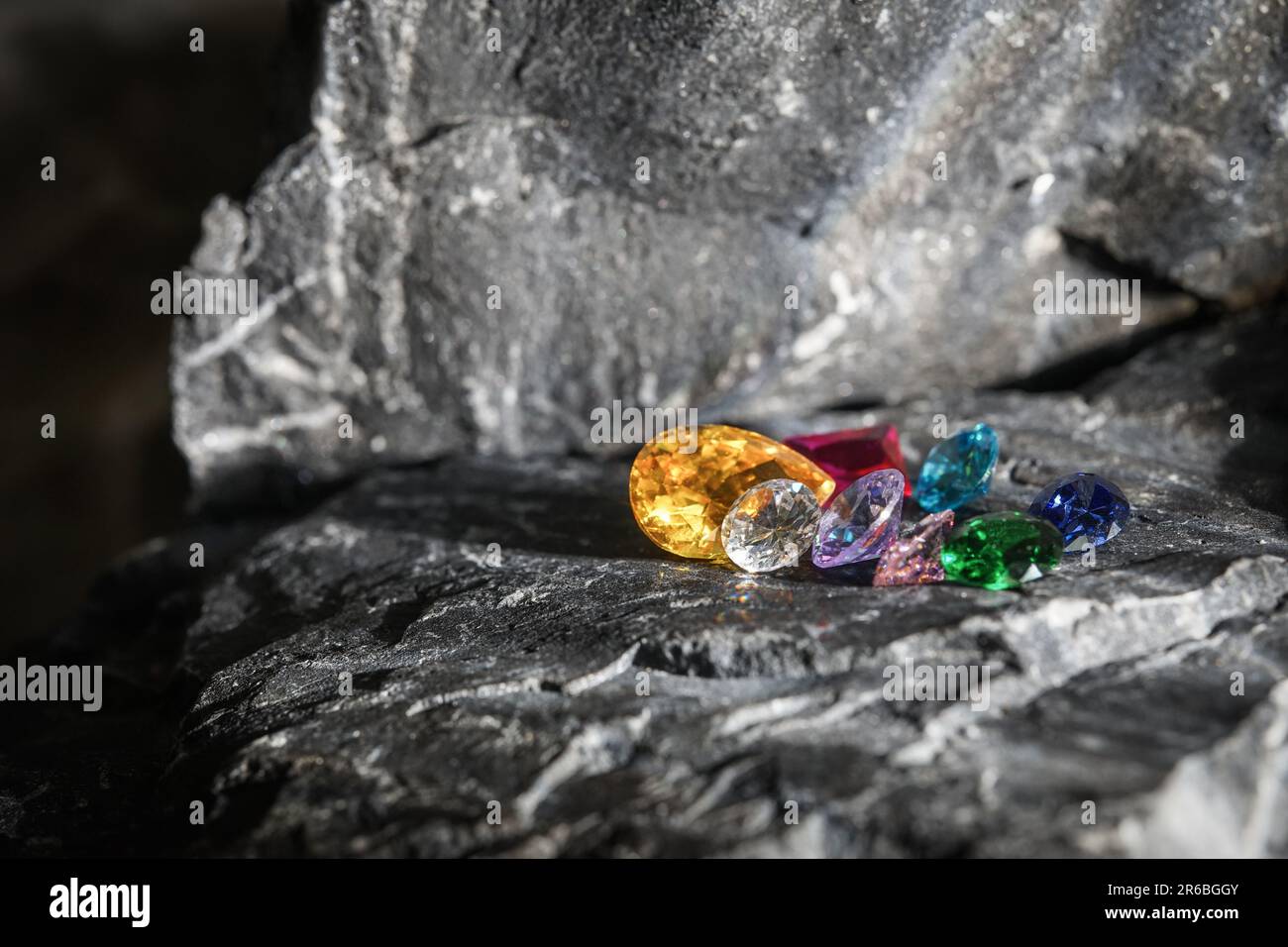 The glimmering natural colorful sapphire gemstones on a rugged rock ...