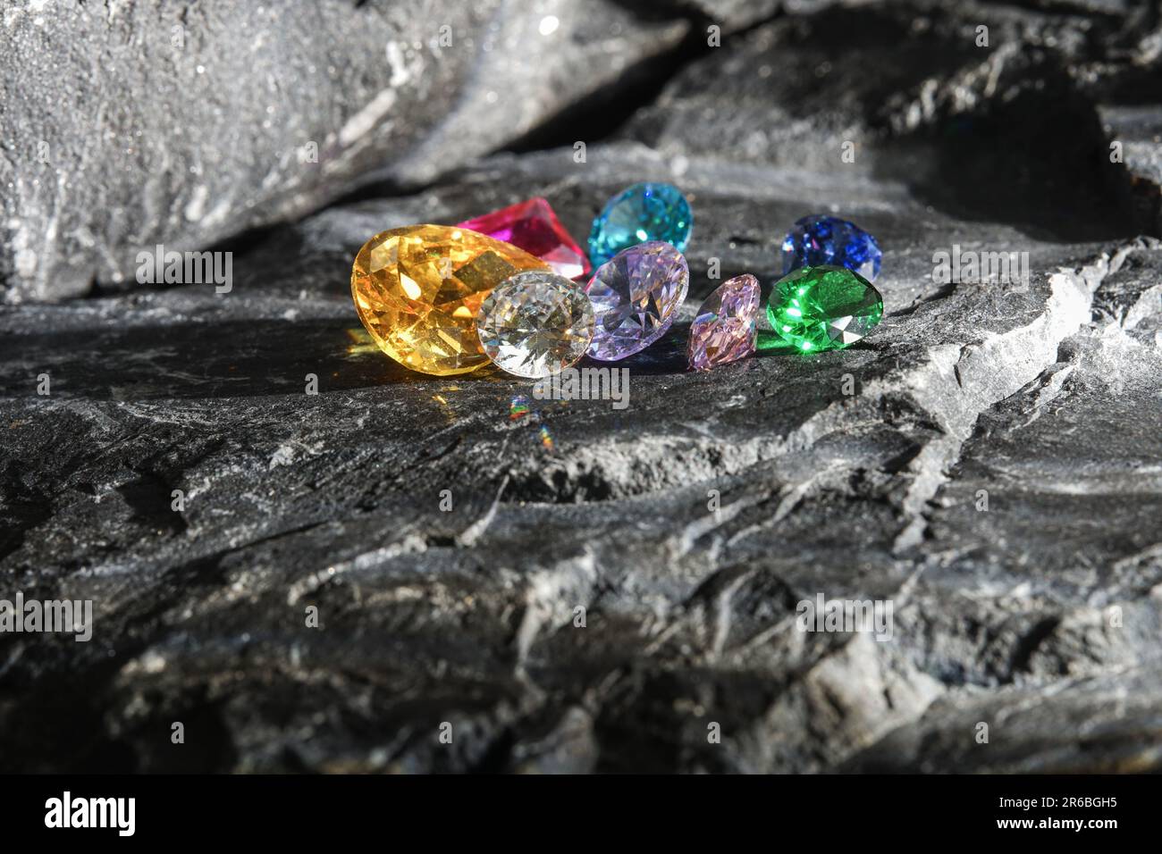 The glimmering natural colorful sapphire gemstones on a rugged rock ...