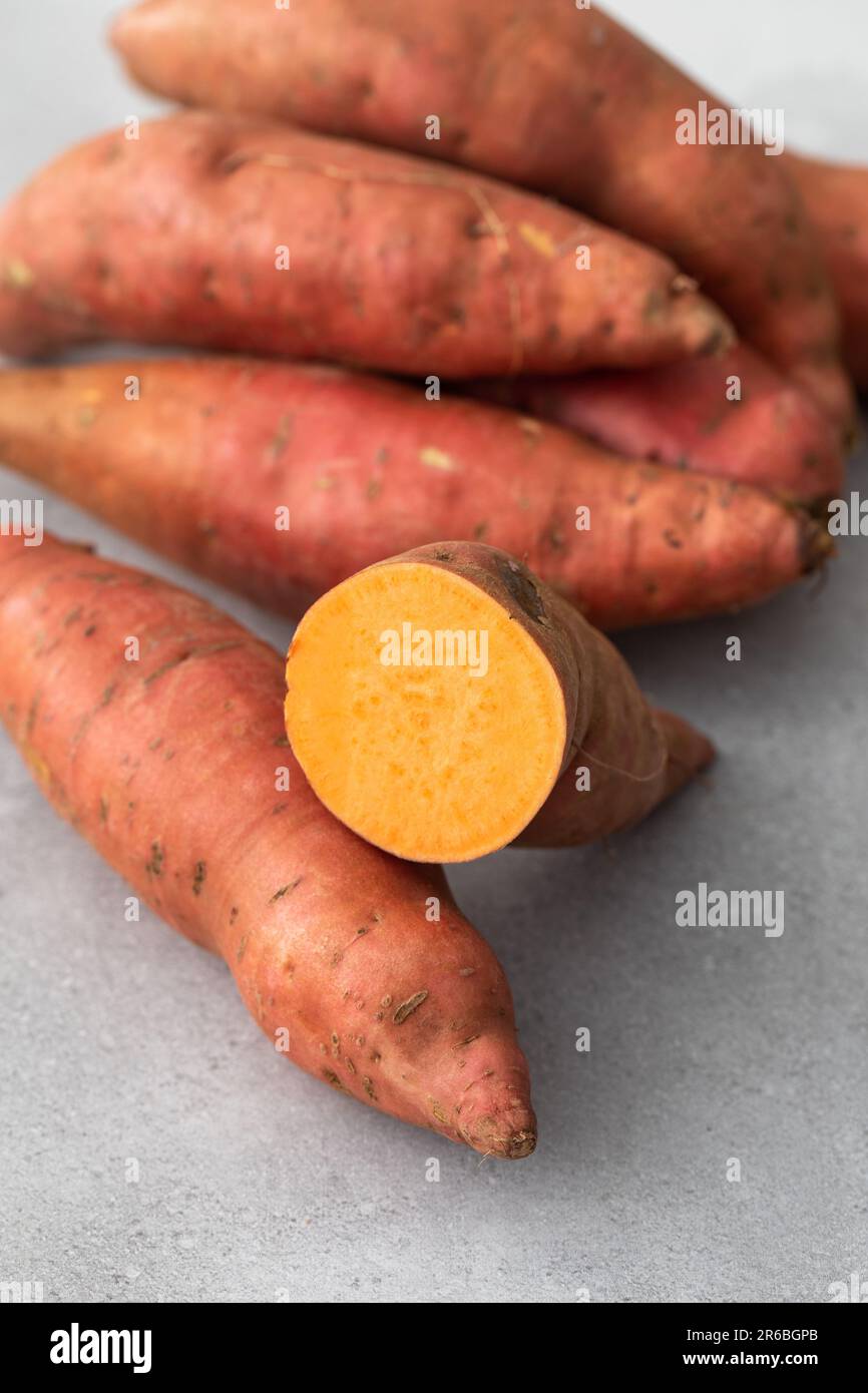 Raw sweet potatoes whole and cut. Orange kumara, sweet potato ...