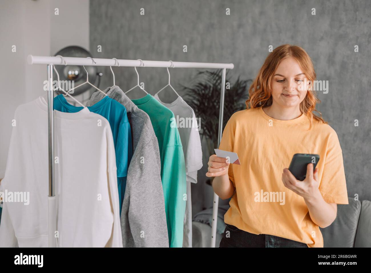Image of pleased Caucasian young adult woman using cell phone, reading ...