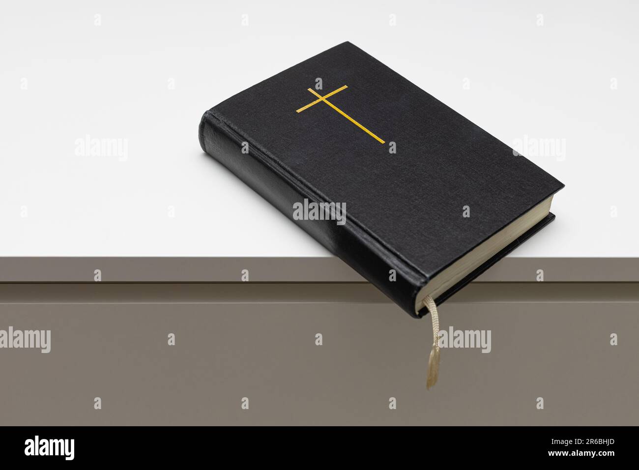 a closed bible with a cross on the cover lies on the table. bible ...