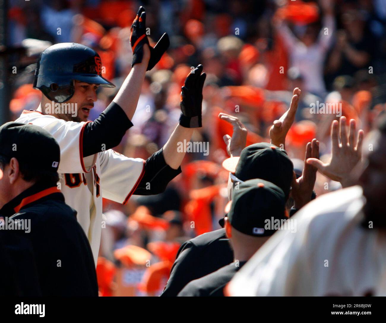 Jonathan Sanchez is greeted in the dugout after scoring the Giants ...
