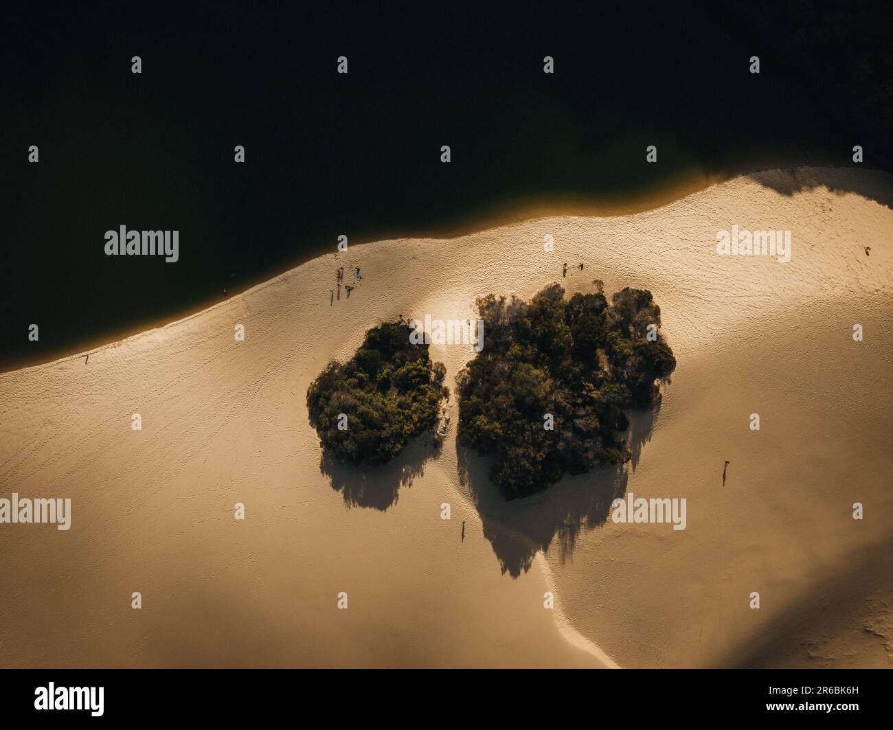 Aerial view of Lake Wabby surrounded by lush rainforest and a massive ...