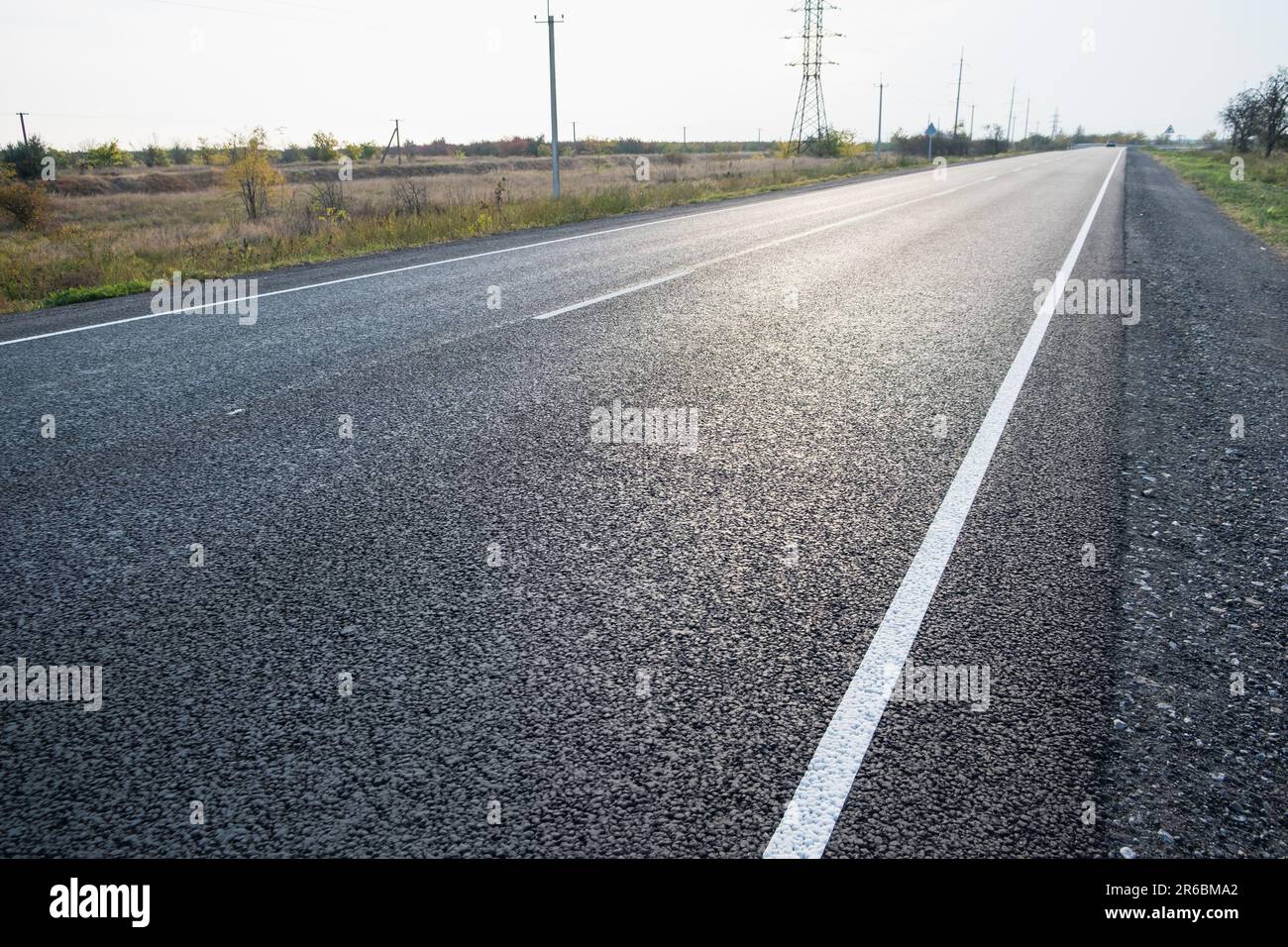 black asphalt road and white dividing lines Stock Photo - Alamy