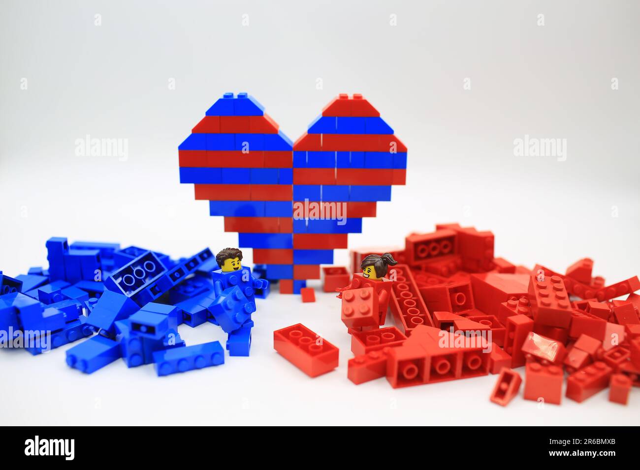 man and woman exchange their own color to create a heart shaped blocks ...