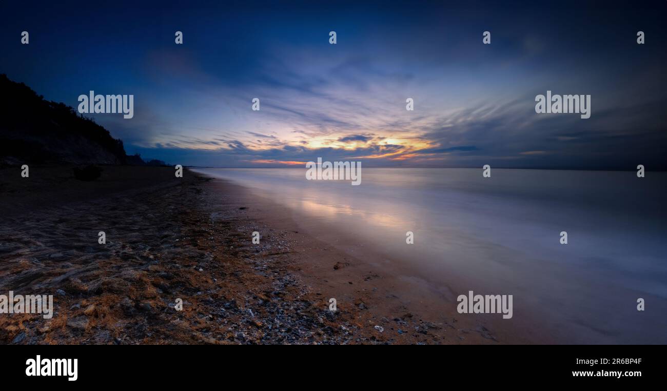 A scenic view of a beach with a vast expanse of blue sky and ocean at ...