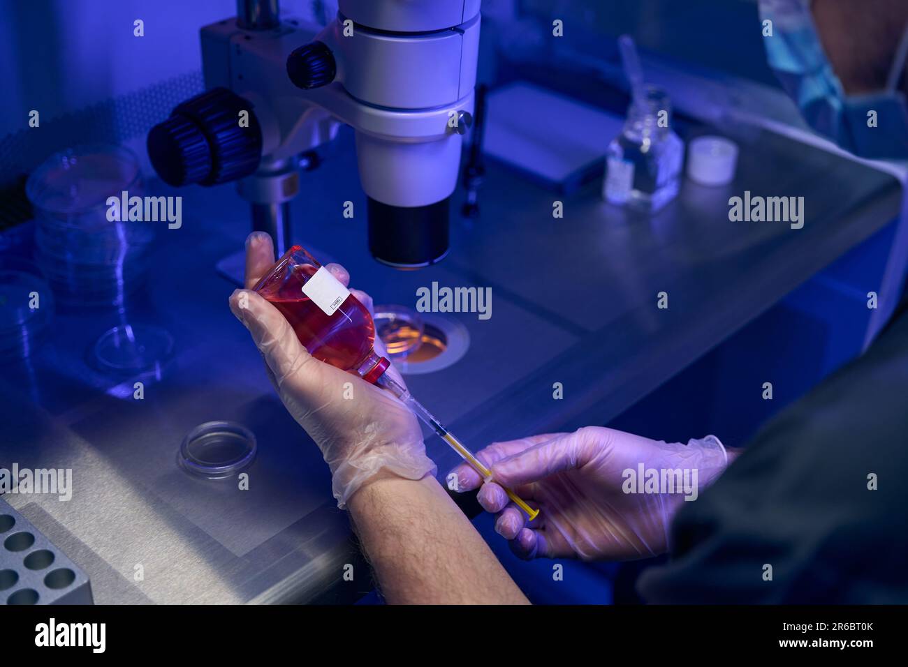 Laboratory worker taking fluid sample with syringe Stock Photo - Alamy