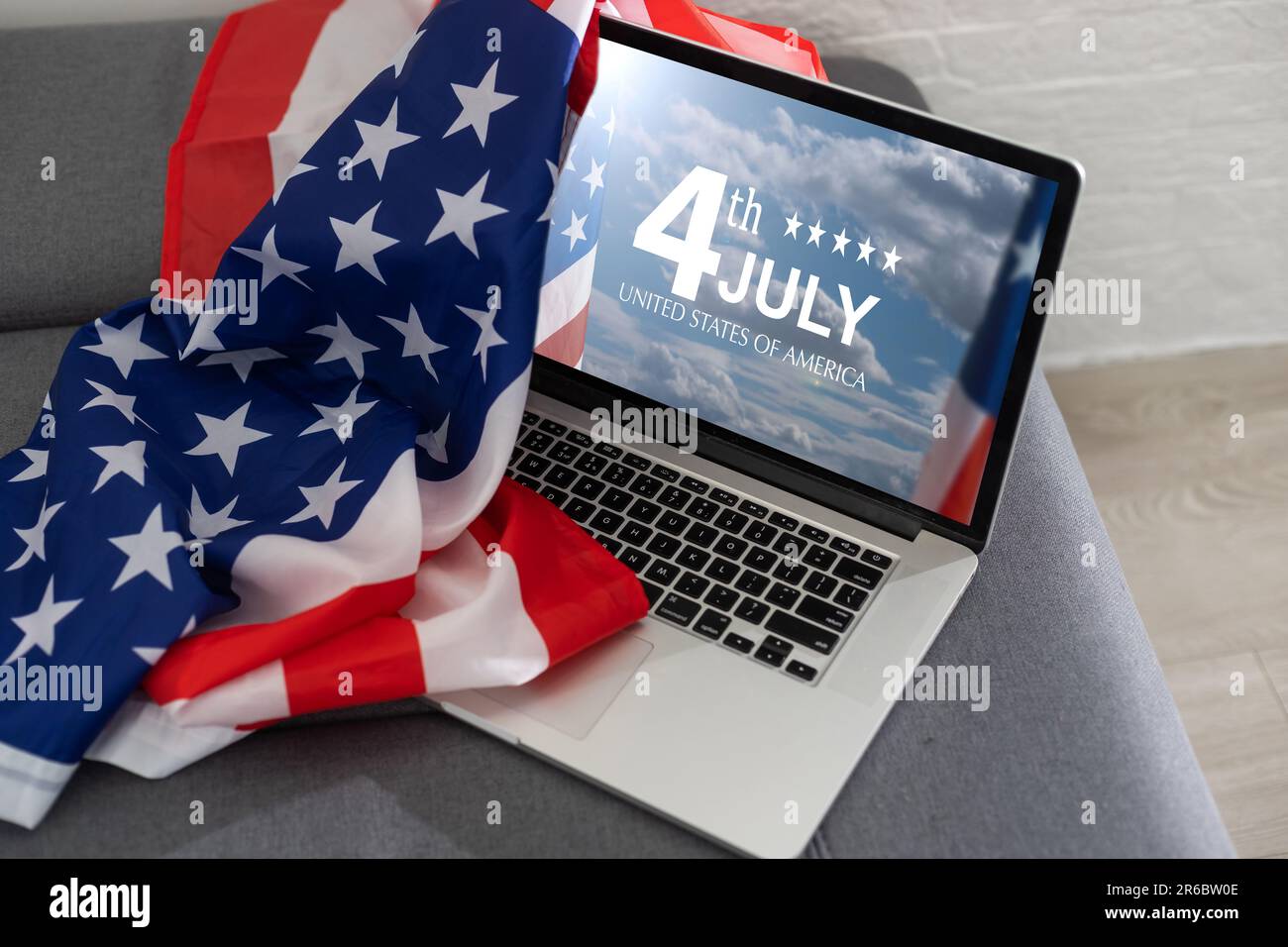 American flag on the desk and laptop screen. Fourth of July Concept ...