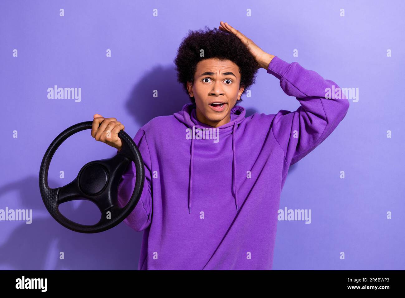 Photo of confused astonished guy afro hairdo dressed purple pullover ...