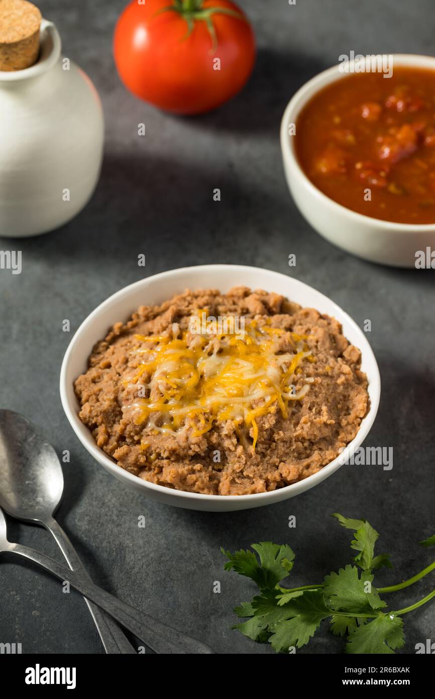 Mexican Homemade Refried Beans with Shredded Cheese Stock Photo - Alamy