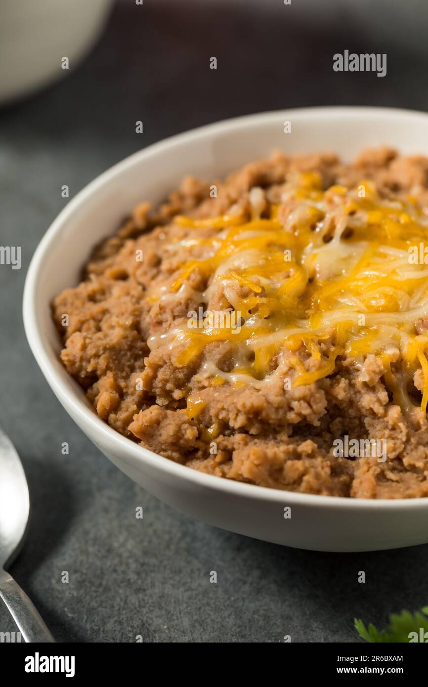 Mexican Homemade Refried Beans with Shredded Cheese Stock Photo - Alamy
