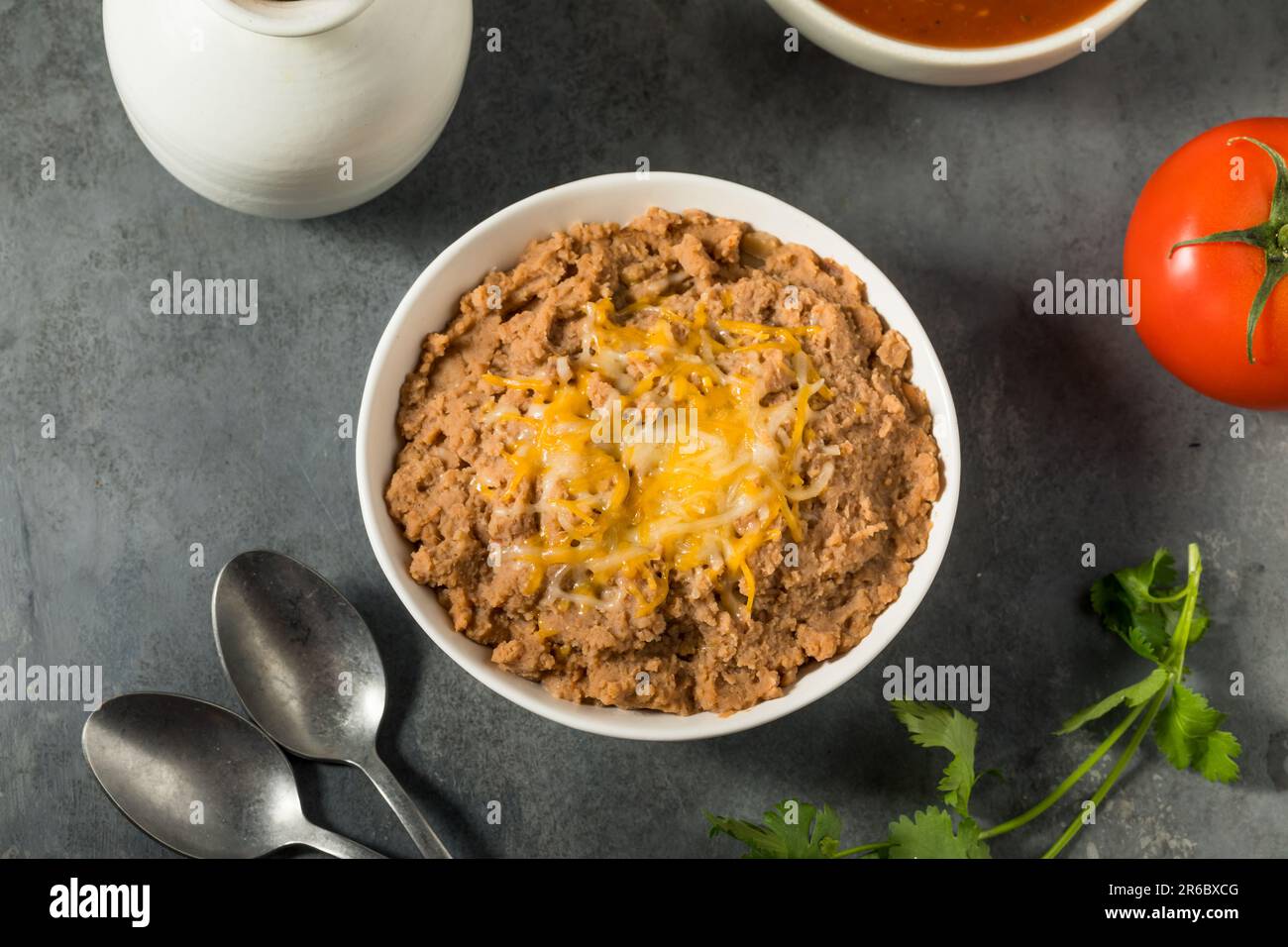 Mexican Homemade Refried Beans with Shredded Cheese Stock Photo - Alamy