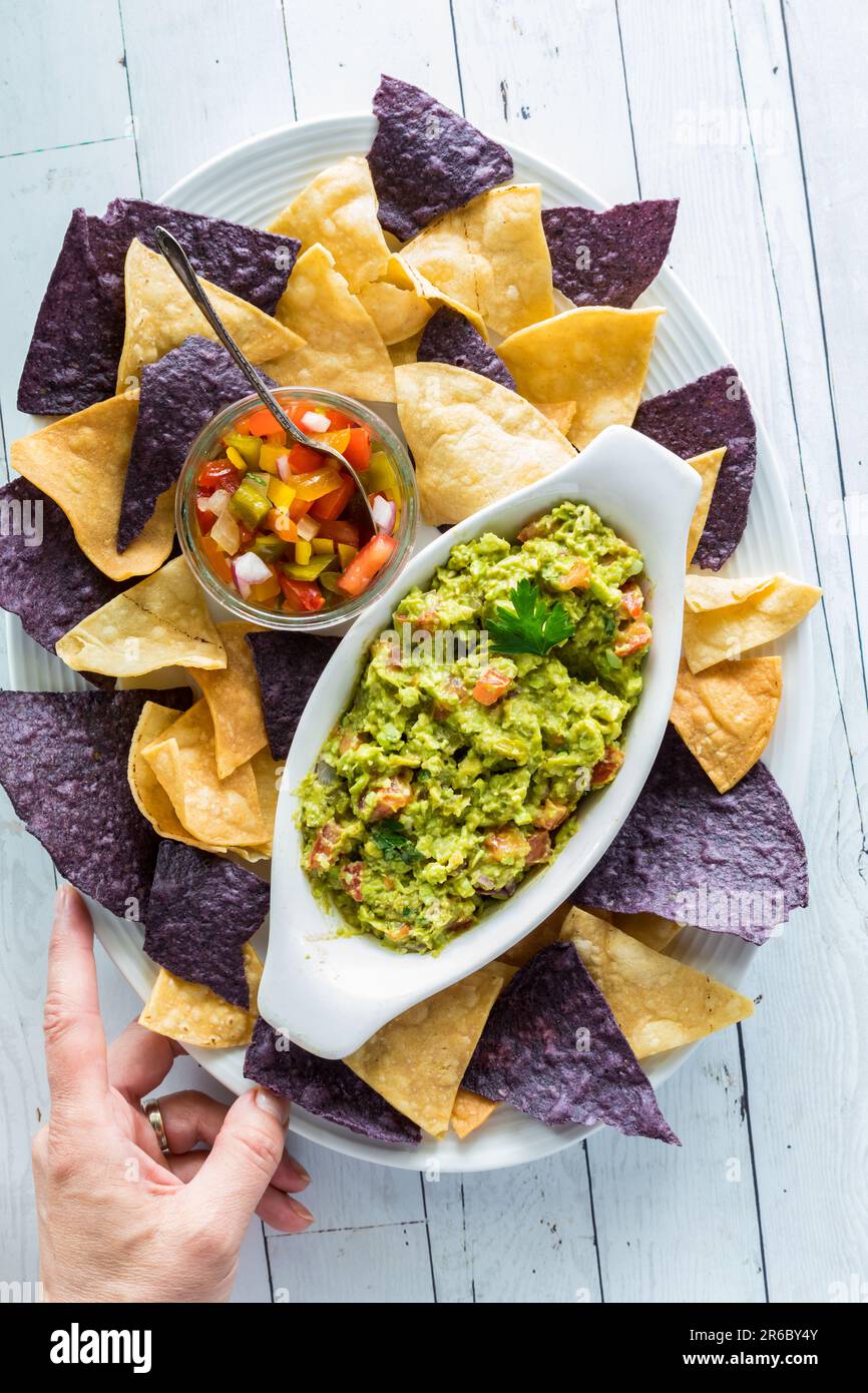 blue and yellow corn tortilla chips served with homemade guacamole and ...