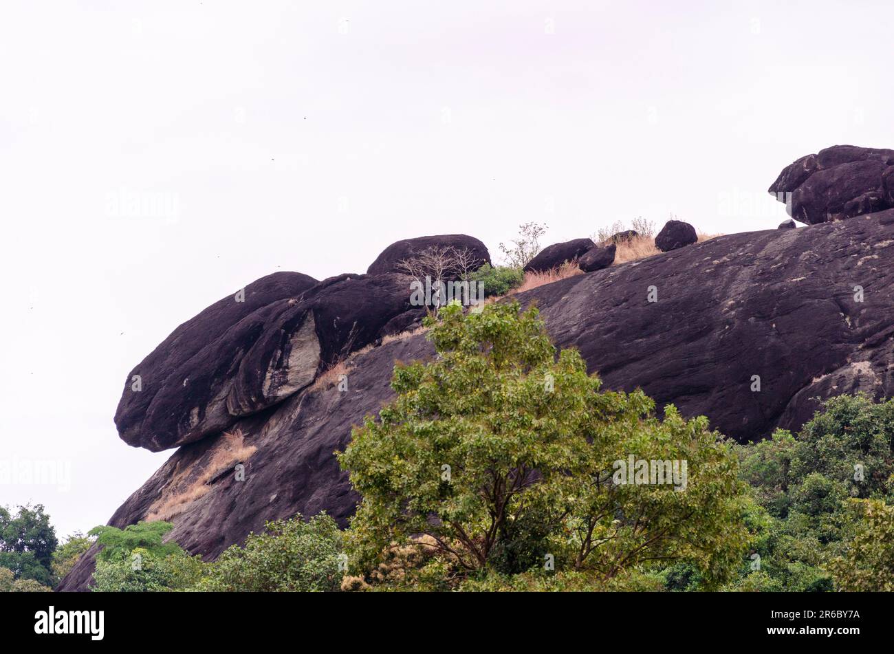 Boulders at a tipping point on another large rock Stock Photo - Alamy