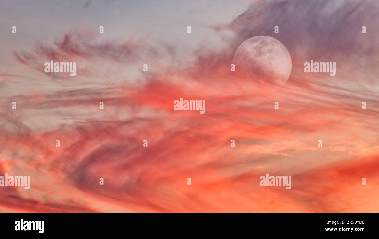 A Full Moon Is Rising In A Colorful Sunset Blue Daytime Sky High ...