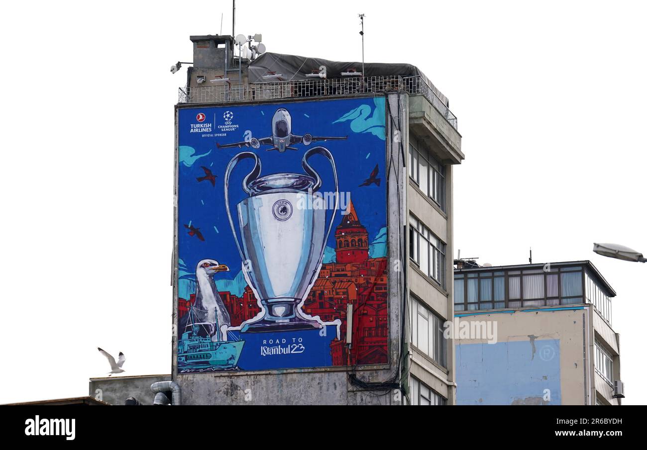 A mural of the UEFA Champions League trophy is seen on the side of a ...