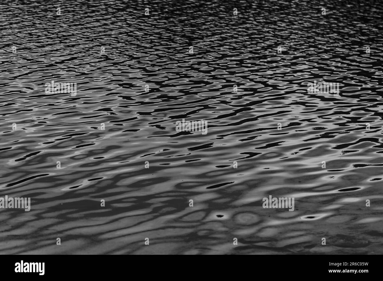 Black water surface with waves. Water ripples. Texture of the water ...