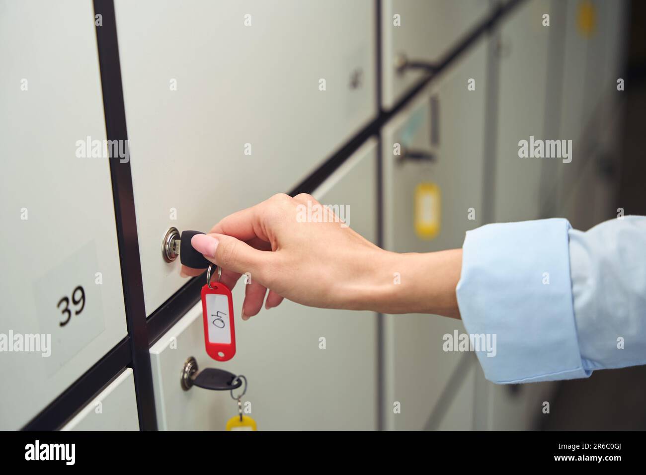 Adult person opening closed storage locker cabinet door Stock Photo - Alamy