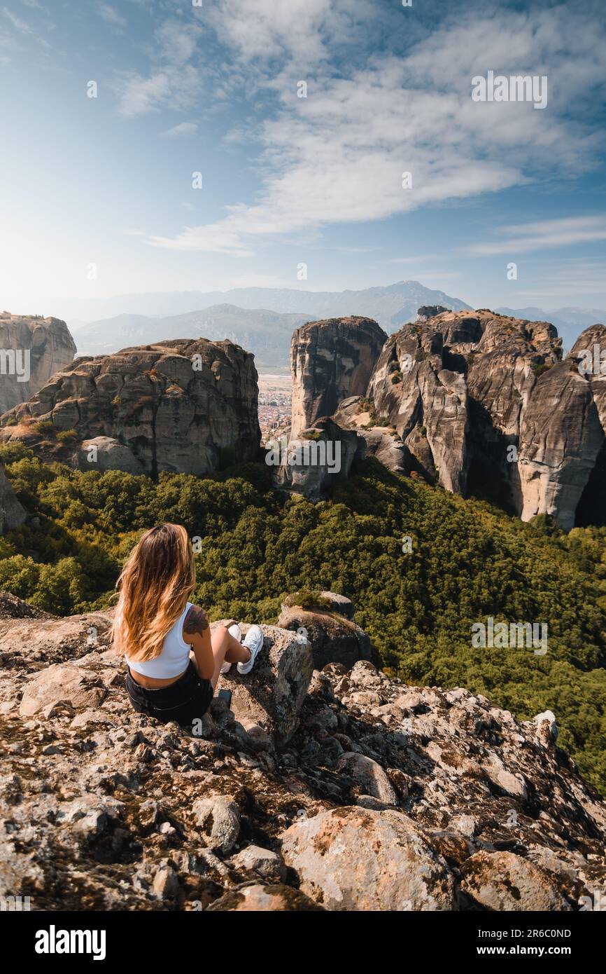 Young woman sitting contemplating the beautiful rocky landscape of the ...